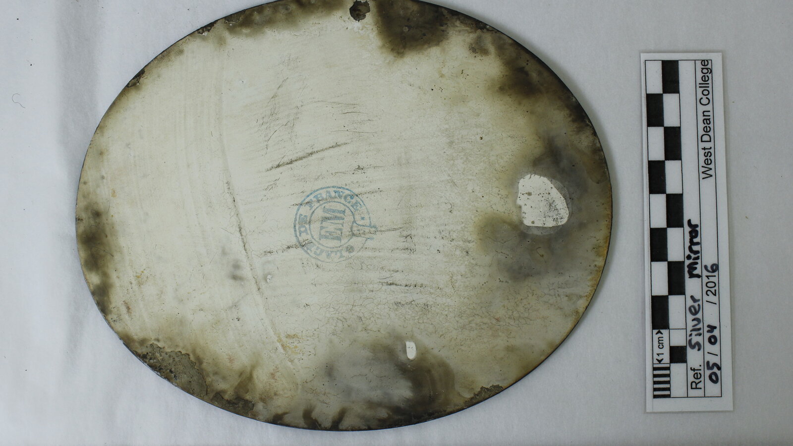 Backing covering the silvering